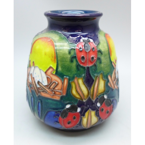 A Moorcroft pottery ladybug and bird nest pattern vase, designed by ...