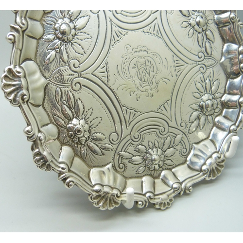 A George III silver salver with embossed floral design and monogram ...