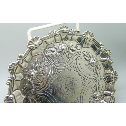 A George III silver salver with embossed floral design and monogram ...