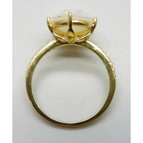 A silver gilt ring set with a faceted stone, U