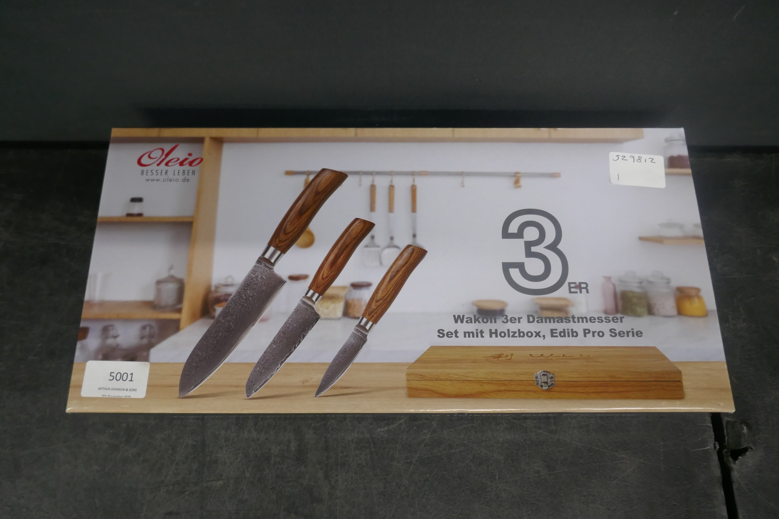 A set of 3 kitchen knives with Damascus blades with a wooden storage ...