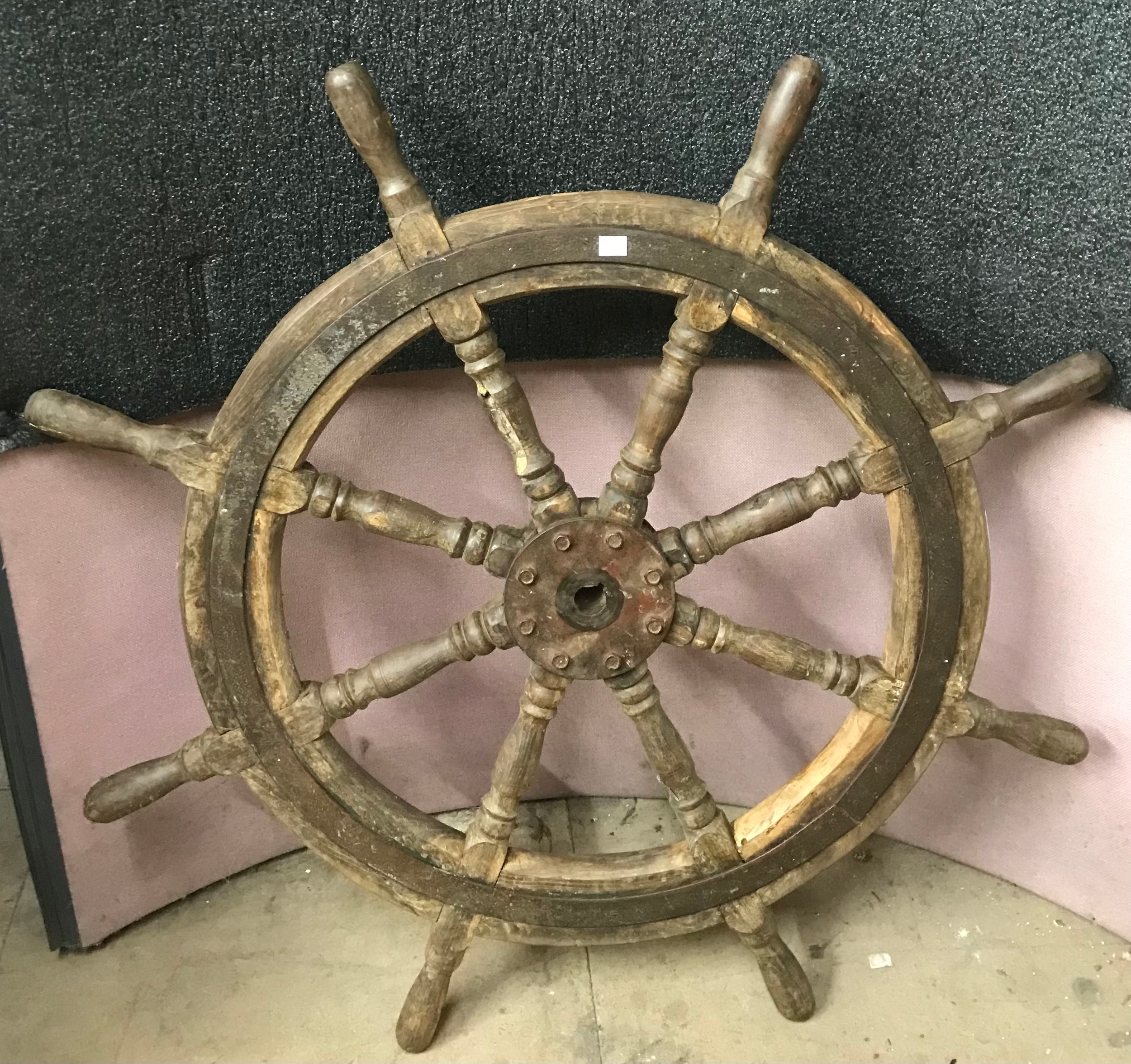 A hardwood and metal bound ship's wheel