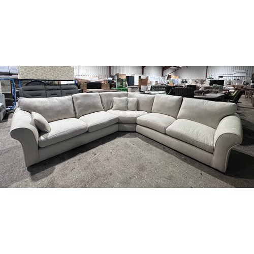 A beige fabric upholstered 3 piece corner sofa (back staples require ...