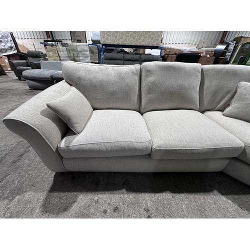 A beige fabric upholstered 3 piece corner sofa (back staples require ...
