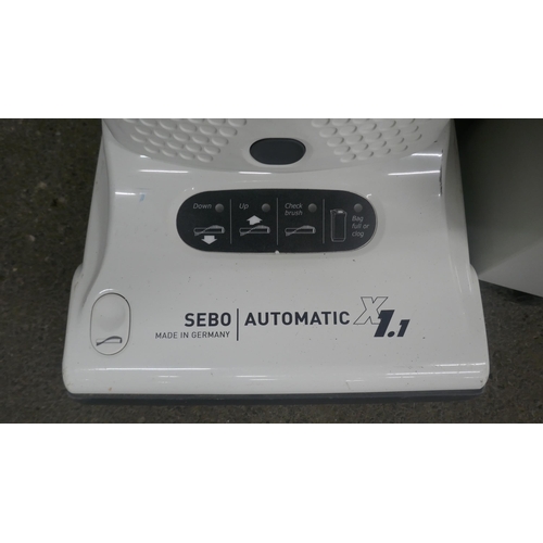 A Sebo Automatic X1.1 upright vacuum cleaner and a Tascrugo Delonghi ...