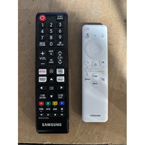 A Samsung 65" LED UHD smart television with two remotes - model no ...