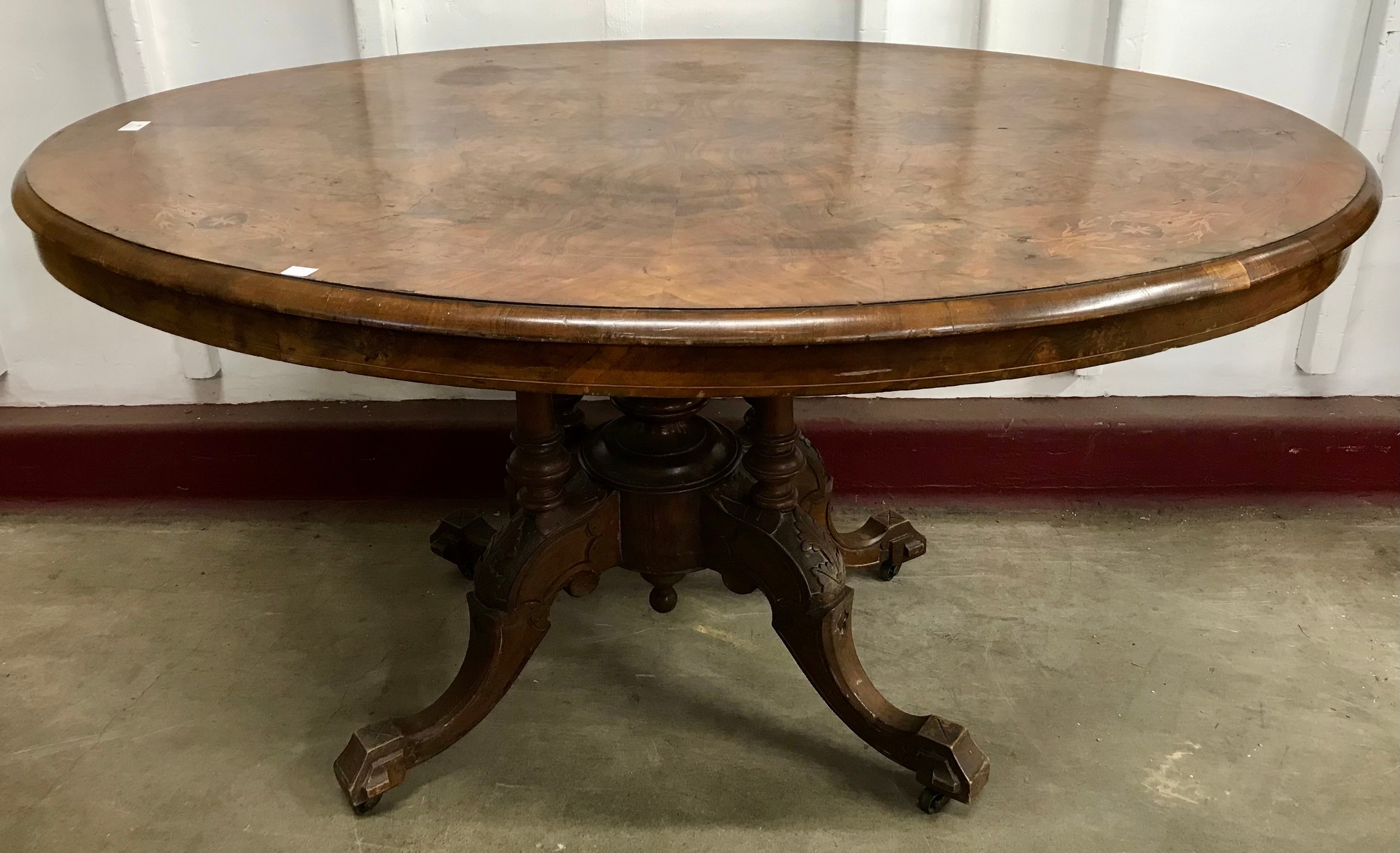 A Victorian inlaid figured walnut oval loo table