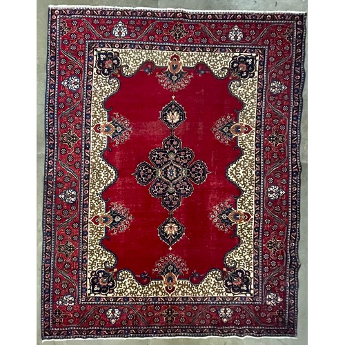 A large Eastern red ground rug, 358 x 255cms