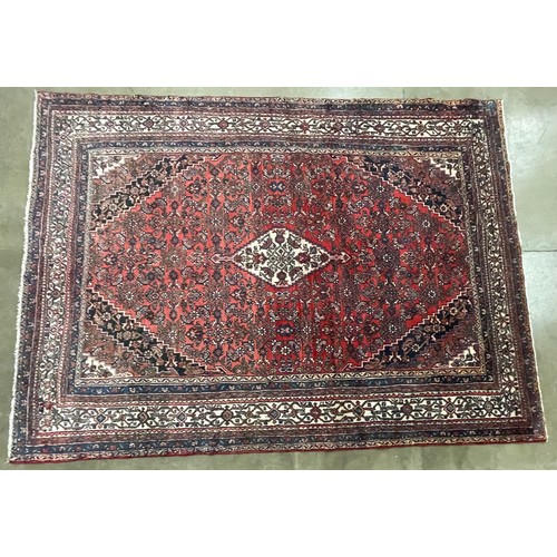 A large Eastern red ground rug, 366 x 264cms