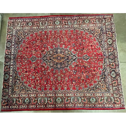 A large Eastern red ground rug, 369 x 292cms