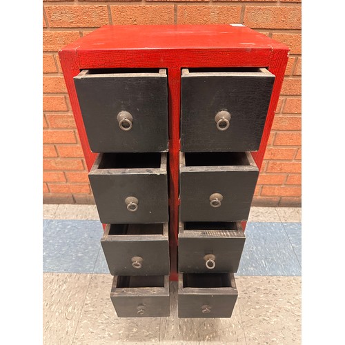A red and black crackle effect 8 drawer chest