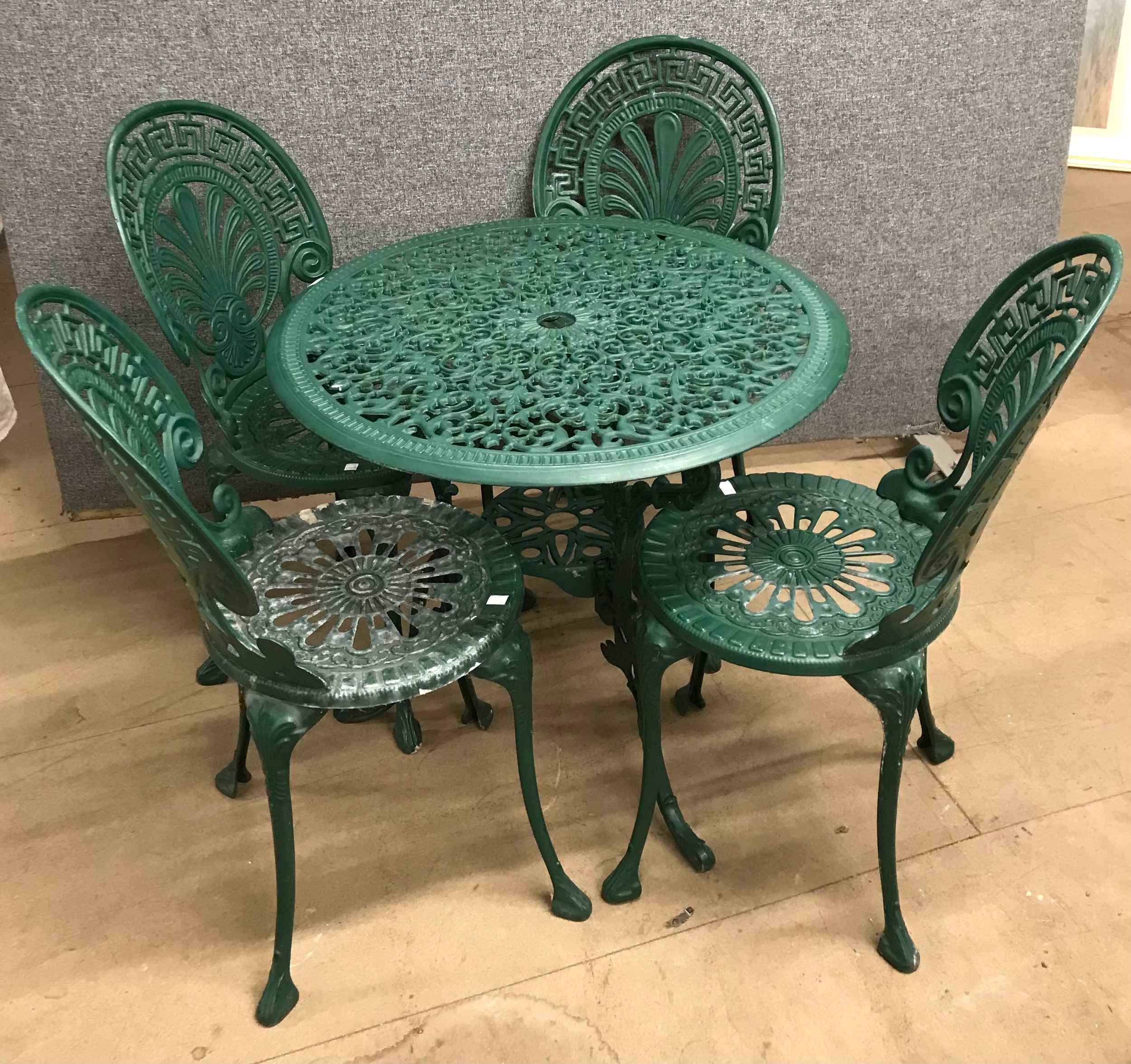A Victorian style cast alloy green painted garden table and four chairs