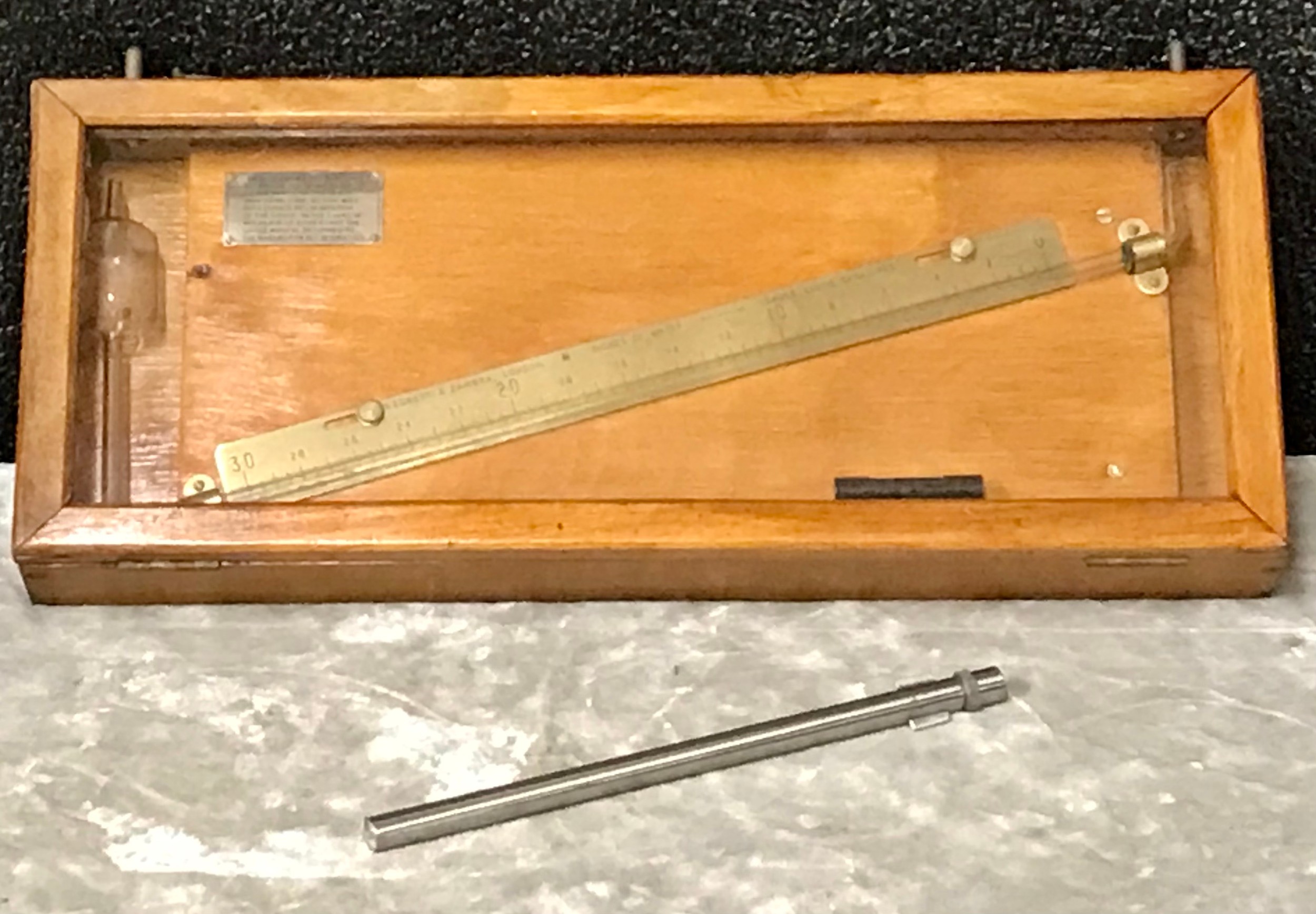 A Negretti & Zambra cased inclinometer and a thermometer