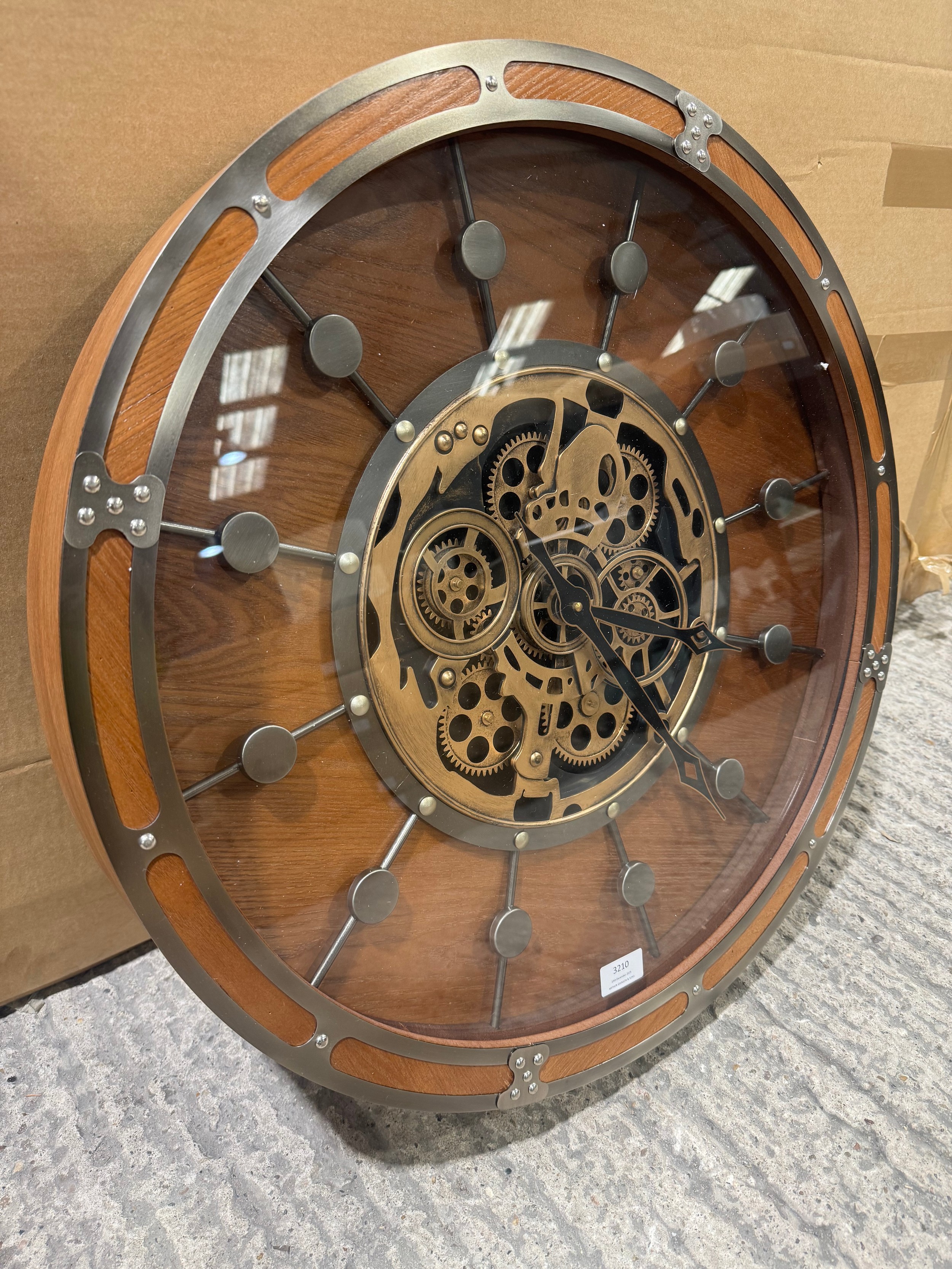 A nautical style circular frame moving gear wall clock (display)