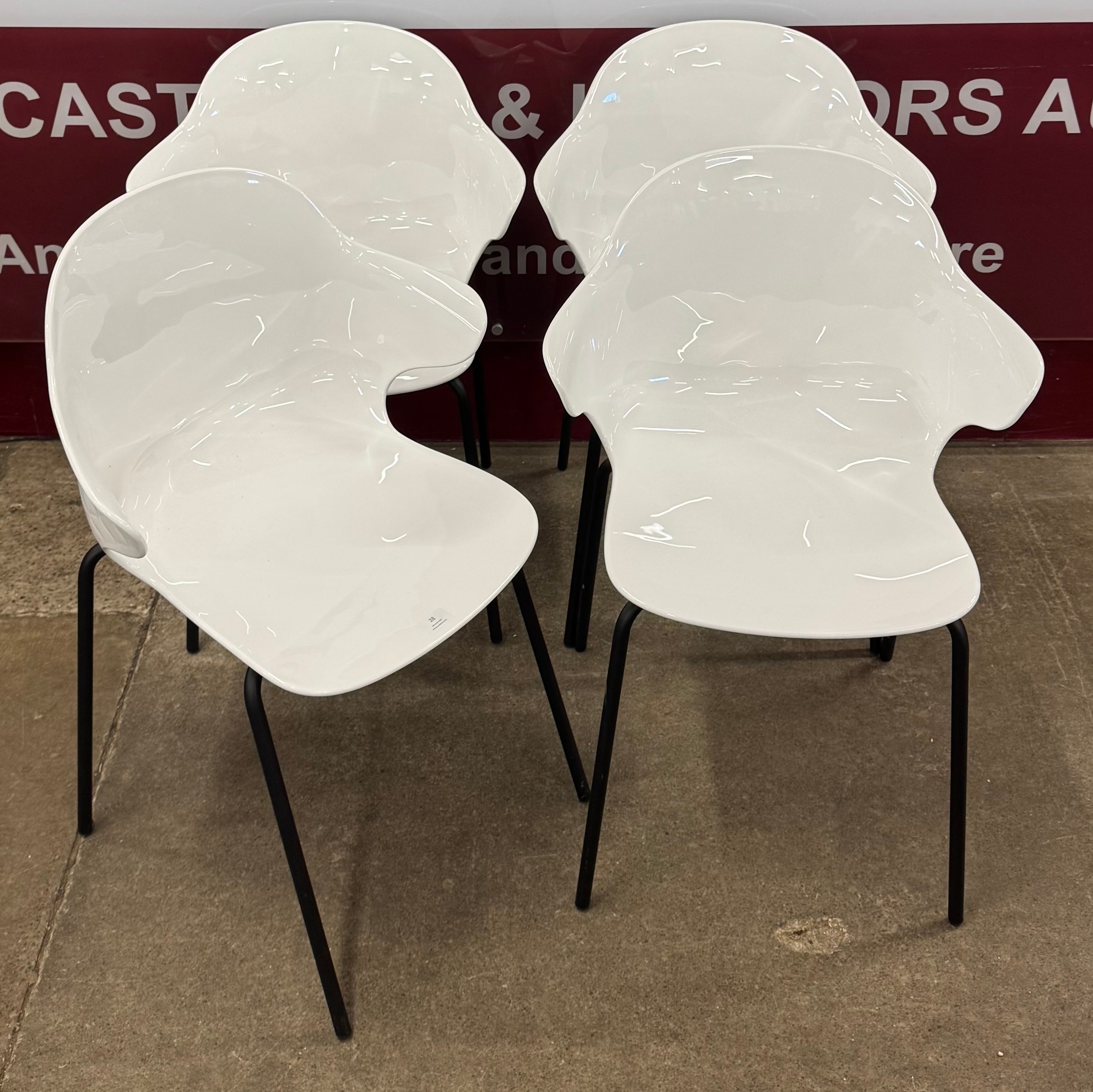 A set of four Italian Calligaris white perspex and black tubular metal ...