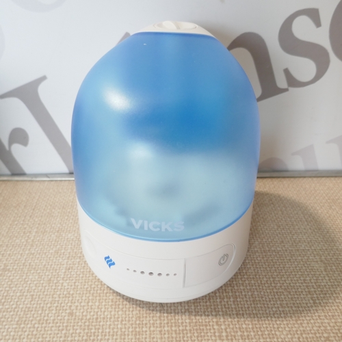 A digital LED clock with temperature and a Vicks personal humidifier ...