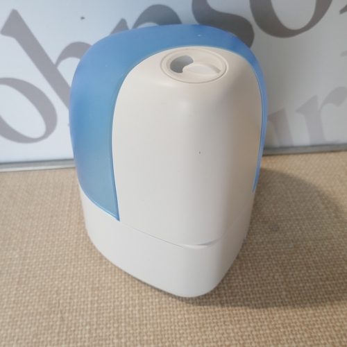 A digital LED clock with temperature and a Vicks personal humidifier ...