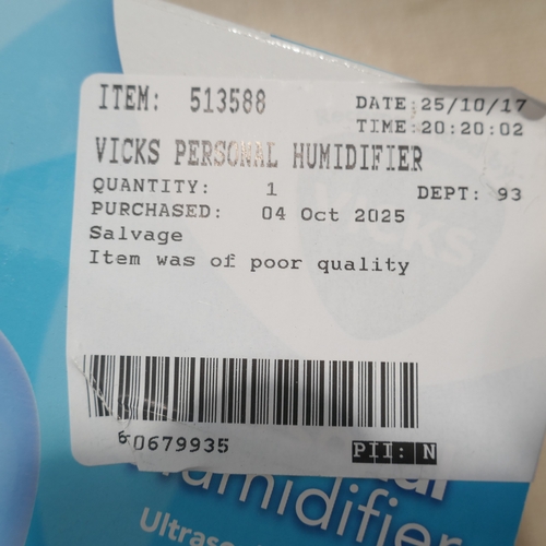 A digital LED clock with temperature and a Vicks personal humidifier ...