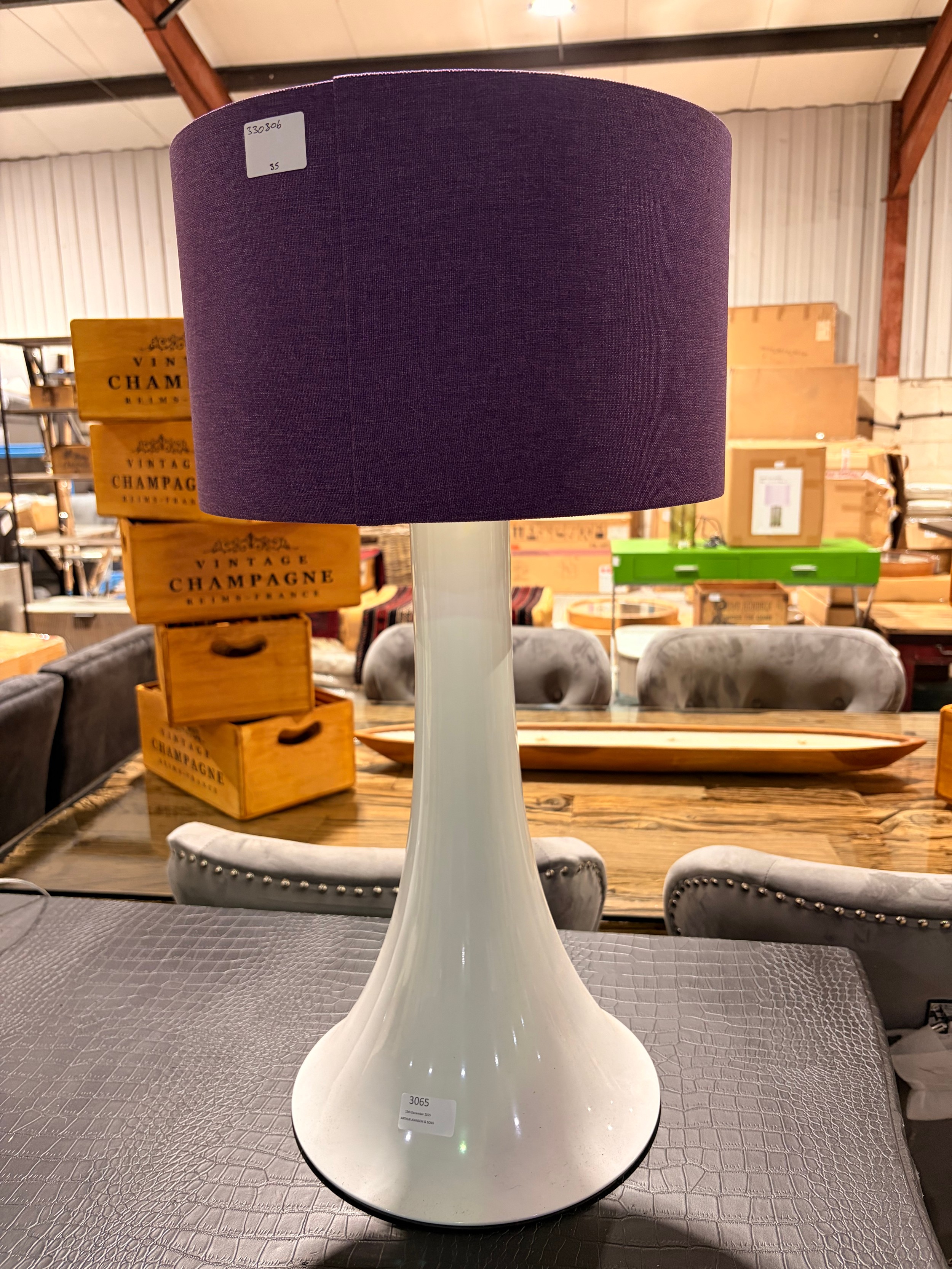 A white table lamp with a purple shade