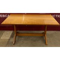 A teak rectangular dining table