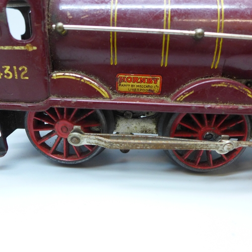 A Hornby O gauge clockwork model railway locomotive and a wagon