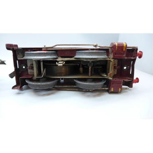 A Hornby O gauge clockwork model railway locomotive and a wagon