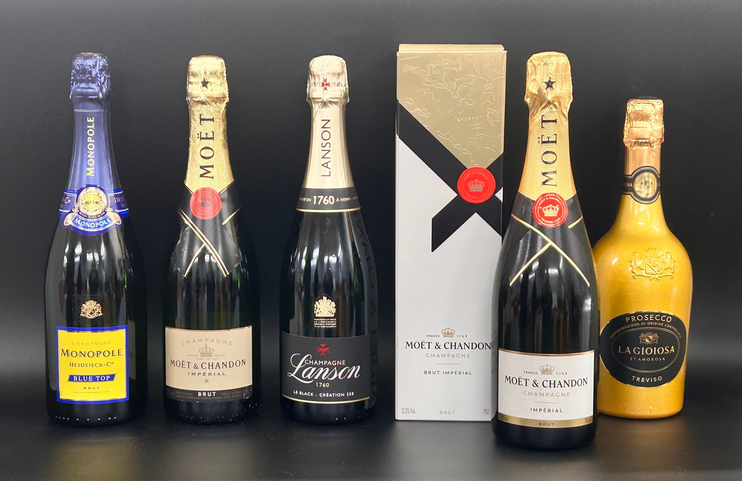 Two bottles of Moet & Chandon champagne, one boxed, a bottle of Lanson ...