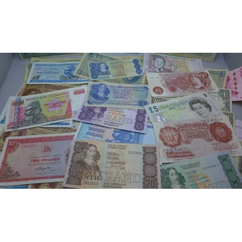 A collection of world bank notes including USA, UK, Zimbabwe, South ...