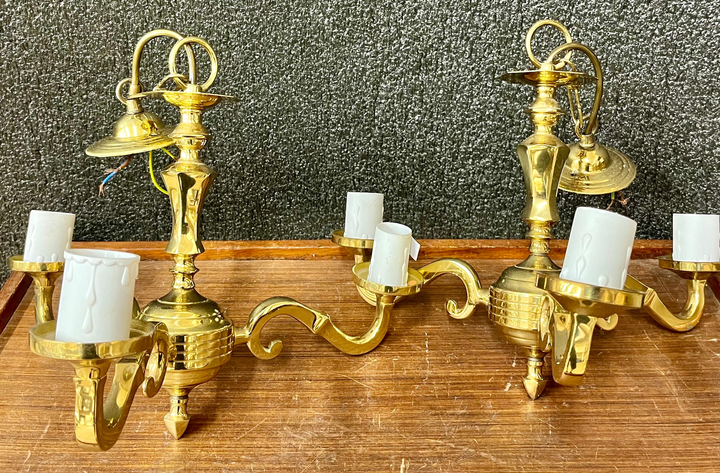 A pair of brass three branch chandeliers. This lot is being sold as ...