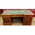 A Victorian style hardwood and green leather topped partners desk