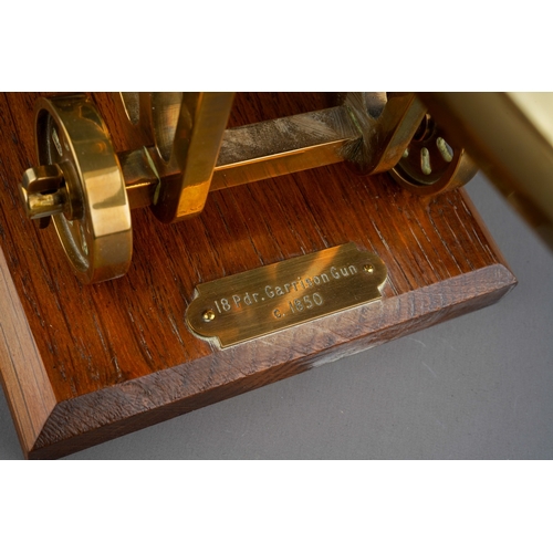 A brass model of a 18 Pdr. Garrison Gun from circa 1850, on oak base