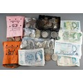 A small cash tin and a quantity of loose coins and banknotes, including ...