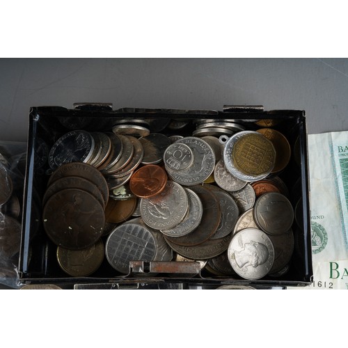 A small cash tin and a quantity of loose coins and banknotes, including ...