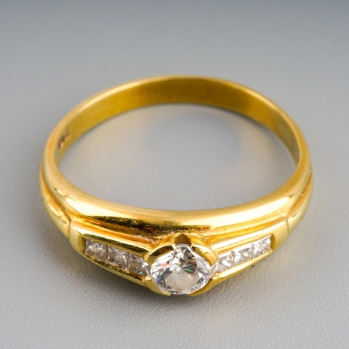 A diamond ring. Set with a principal round brilliant cut diamond ...