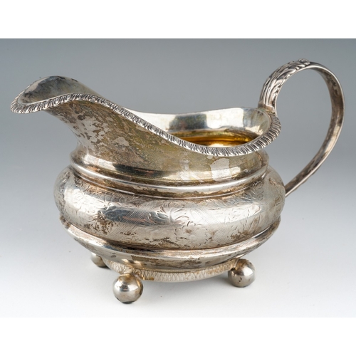 A George IV Provincial silver milk jug, gadroon border, the handle with ...