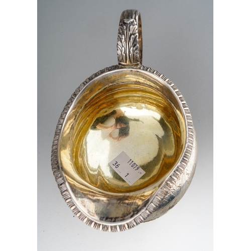 A George IV Provincial silver milk jug, gadroon border, the handle with ...