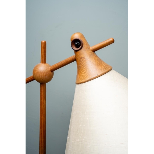 A Danish Dyrlund light teak standard lamp, with switch to the conical ...