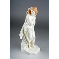 A Belleek style figurine of a lady carrying a bundle of sticks on her ...