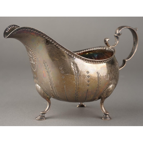 A George III Irish silver sauceboat, embossed beaded rim, the sauceboat ...