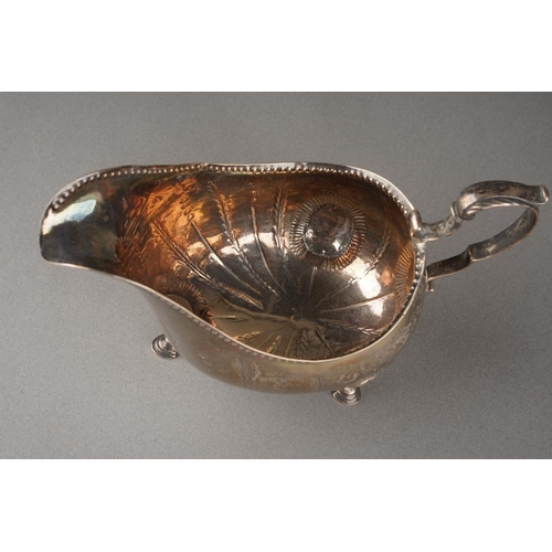 A George III Irish silver sauceboat, embossed beaded rim, the sauceboat ...