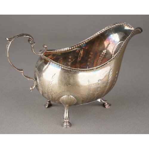 A George III Irish silver sauceboat, embossed beaded rim, the sauceboat ...
