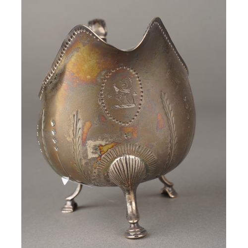 A George III Irish silver sauceboat, embossed beaded rim, the sauceboat ...