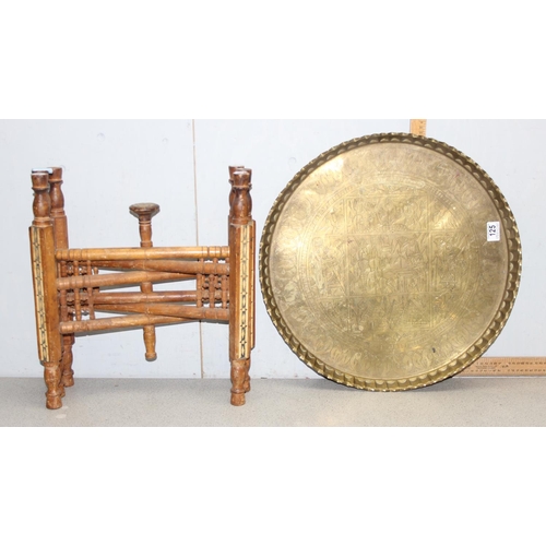 A vintage brass topped Benares folding tea table, approx 53cm in diameter