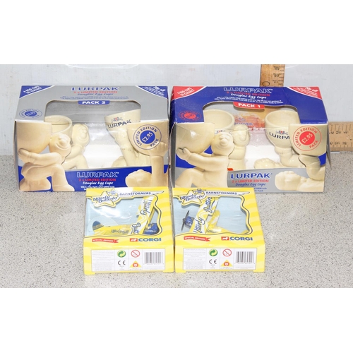 Qty of Lurpak collectables, 2 boxed egg cups and 2 Corgi bi-planes