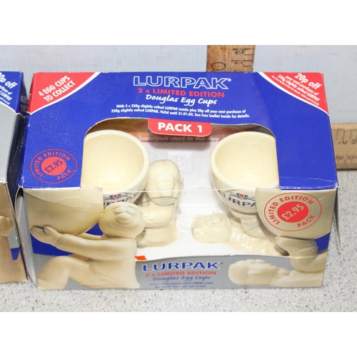 Qty of Lurpak collectables, 2 boxed egg cups and 2 Corgi bi-planes