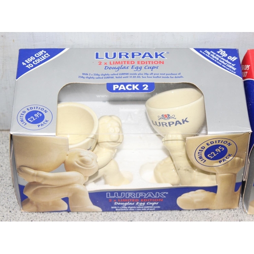 Qty of Lurpak collectables, 2 boxed egg cups and 2 Corgi bi-planes