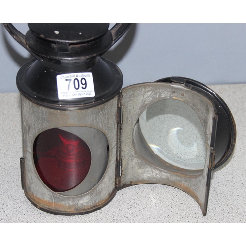 A vintage railway signal lamp marked L.T. with red and green lights
