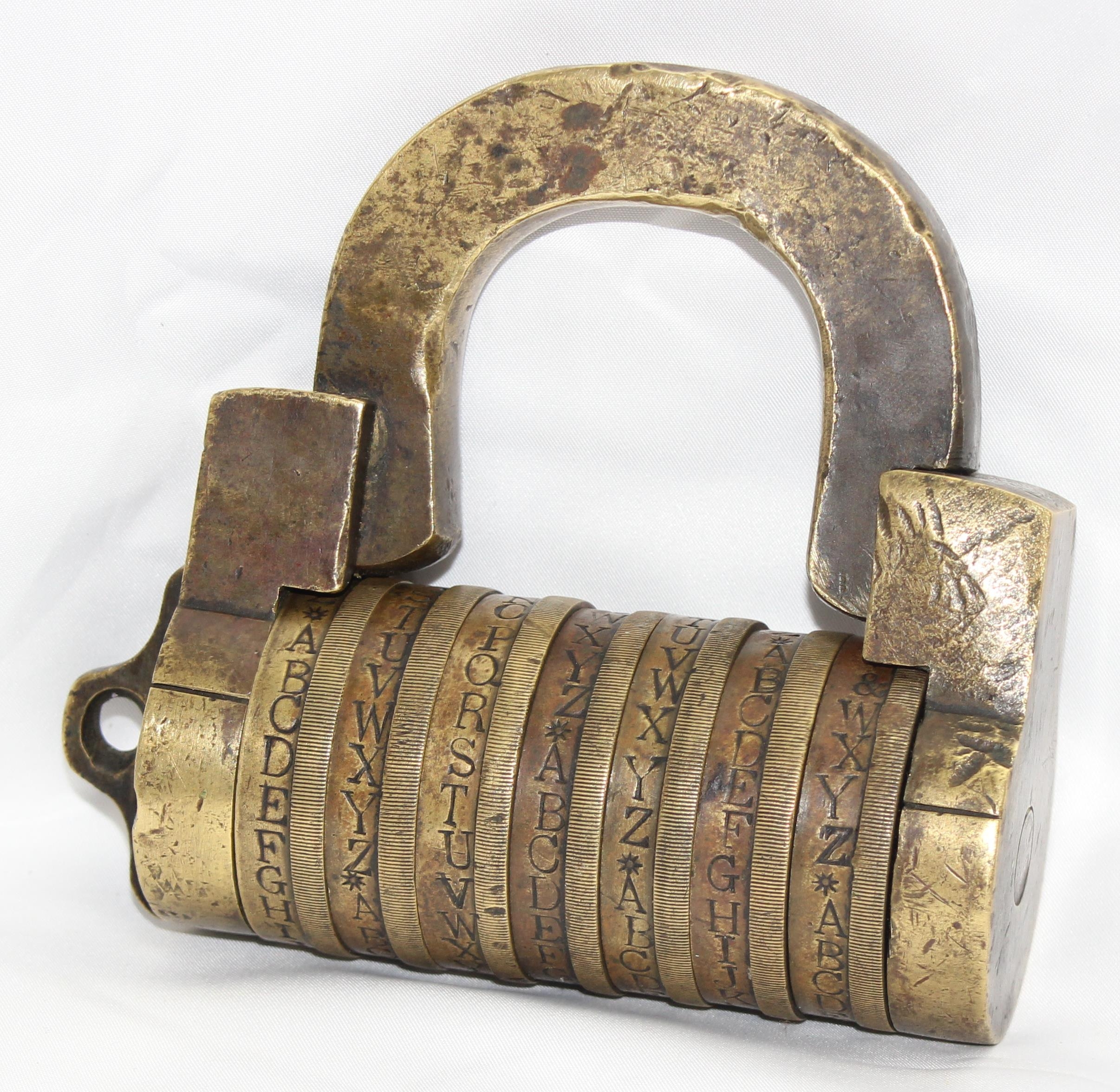 A rare and unusual cryptex style letter coded brass padlock with 7 ...