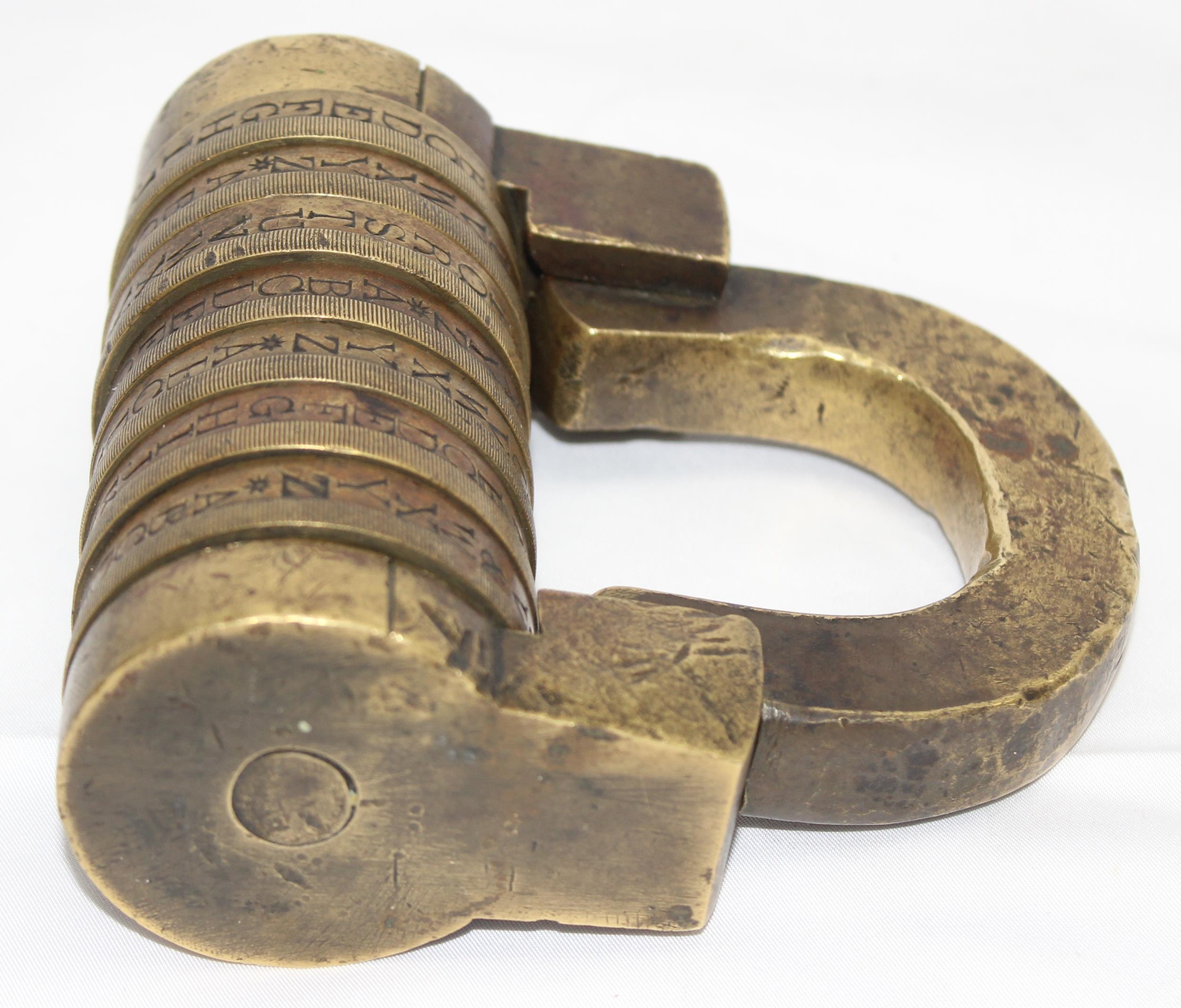 A rare and unusual cryptex style letter coded brass padlock with 7 ...