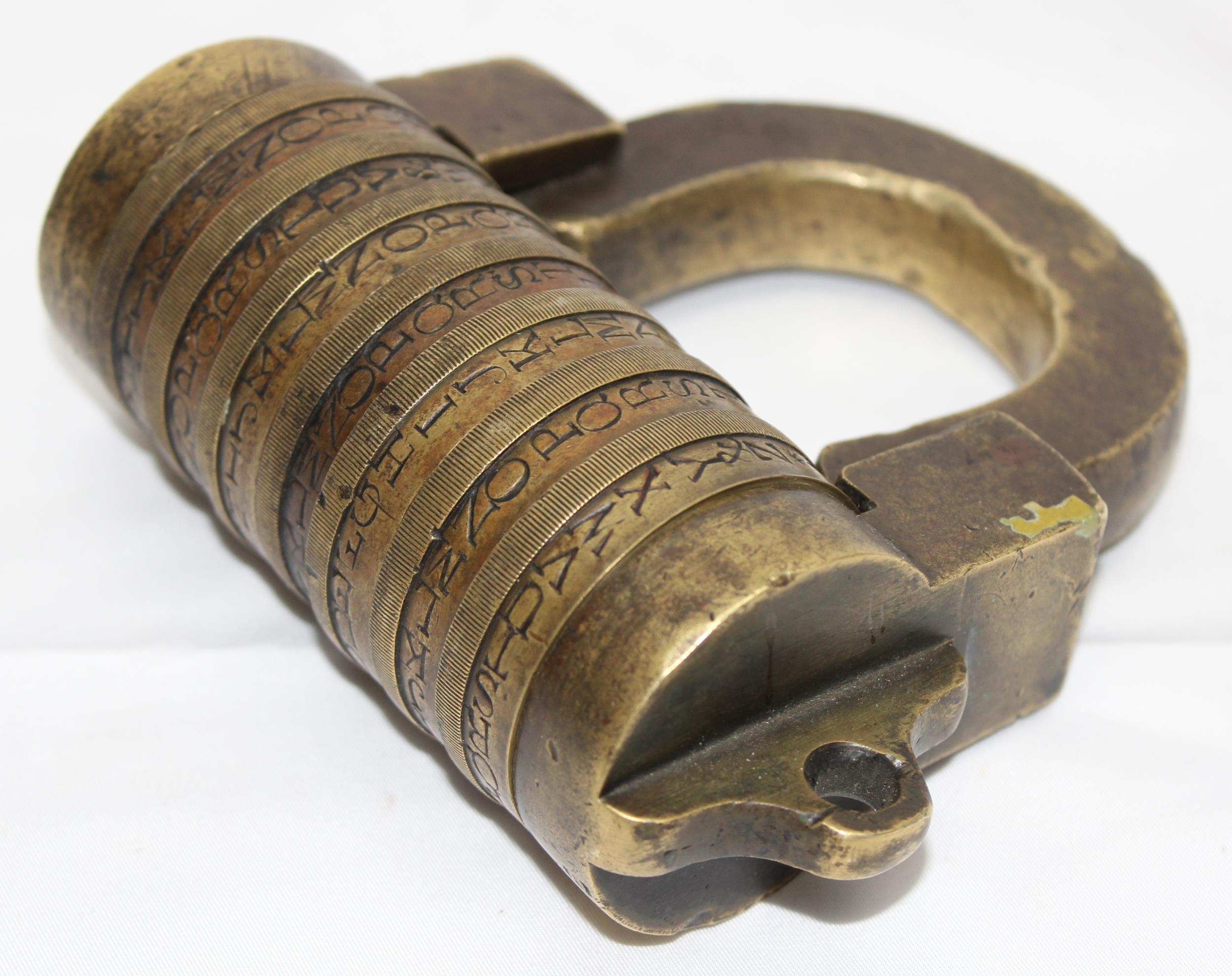 A rare and unusual cryptex style letter coded brass padlock with 7 letter wheels, likely 19th centur